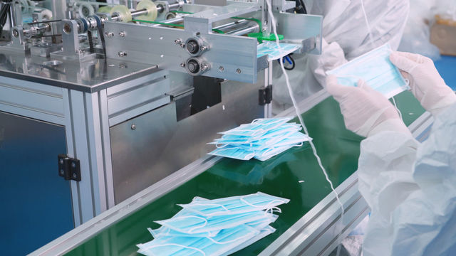 Midsection of person manufacturing mask at | ID: 166897235