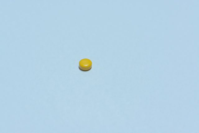 Close-up of yellow tablet against blue | ID: 155729690