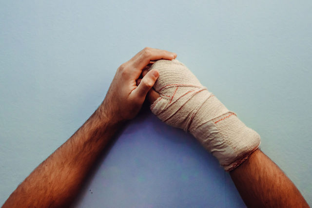 Cropped hand of man wrapped in bandage on | ID: 135258792