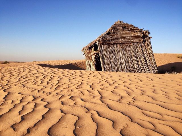 Hut in desert against clear sky | ID: 32473511