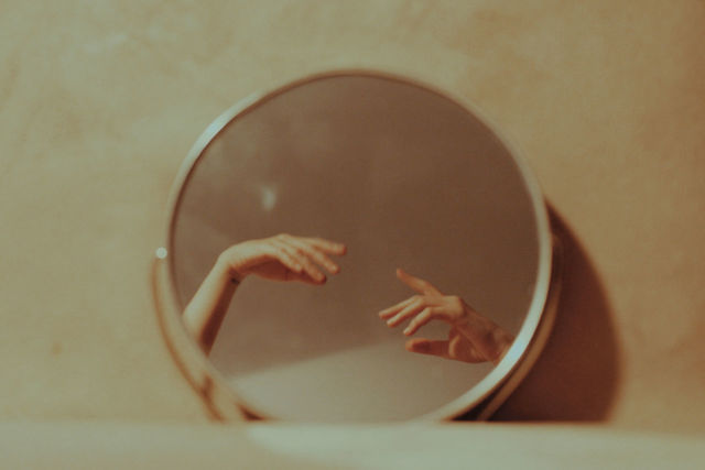 Reflection of woman hands in vanity mirror | ID: 150500033