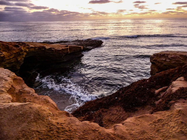 Rocks on sea shore against sky | ID: 147953584