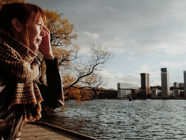 Side view of young woman standing by lake | ID: 198163590