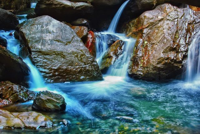 Scenic view of river flowing over rocks in | ID: 88509297