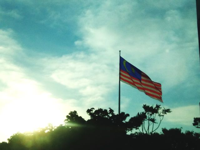 Low angle view of flag flags against cloudy | ID: 124290581