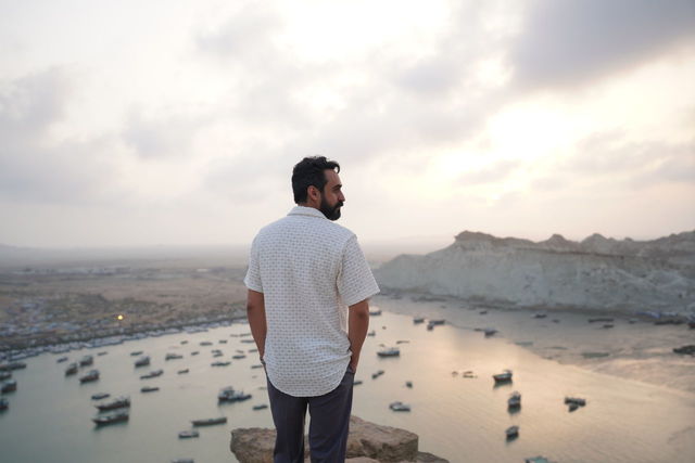 Side view of man standing at beach against | ID: 216399895