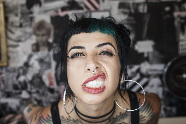 A portrait of a young woman making a face. | ID: 132298622