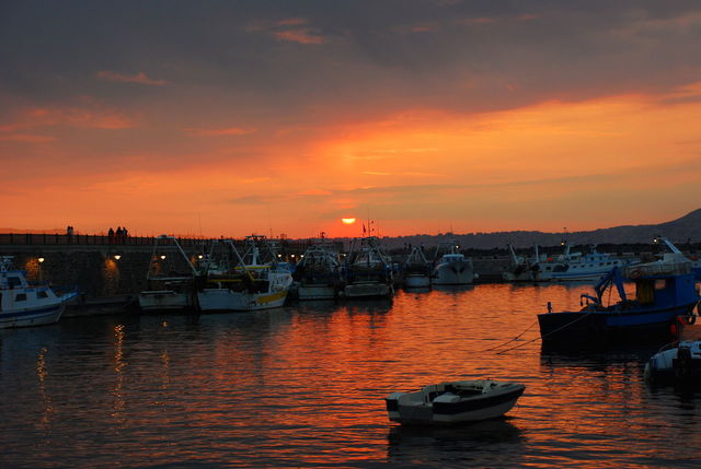 Boats moored at harbor at sunset | ID: 191221493