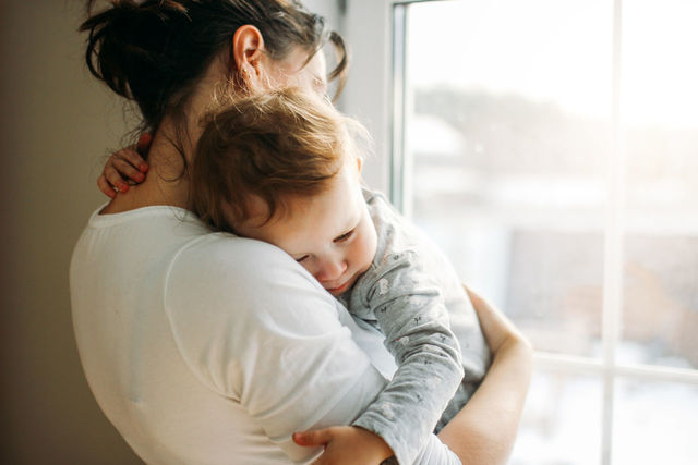 Mother embracing baby girl while standing | ID: 153036469