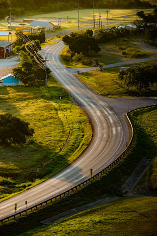 Aerial view of an isolated winding road in | ID: 216086769