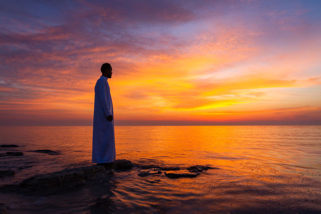 Side view of man standing at beach against | ID: 205698236