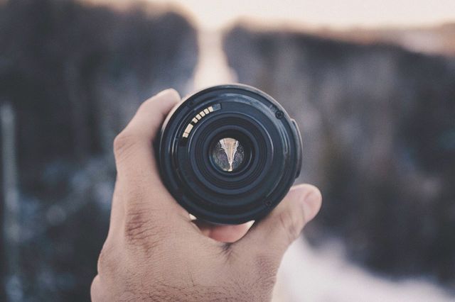 Close-up of hand holding lens | ID: 97601421