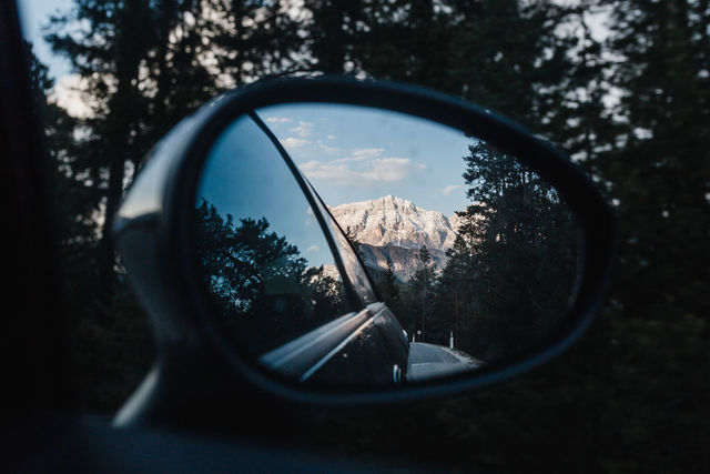 Reflection of mountain in side-view mirror | ID: 104672496