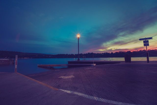 Illuminated street light at riverbank during | ID: 79389395
