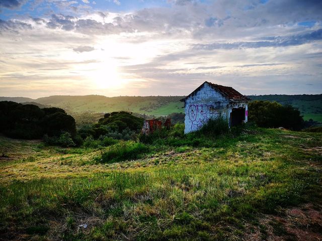 Old house on field by building against sky | ID: 122796016