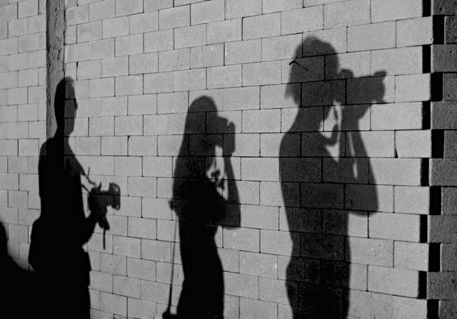 Shadows of three people photographing | ID: 66700398