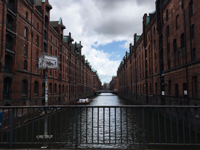 Canal amidst buildings against sky in city | ID: 125846100