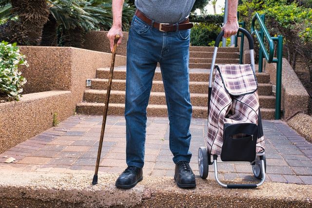 Elderly disabled person with a stick walks | ID: 213863740