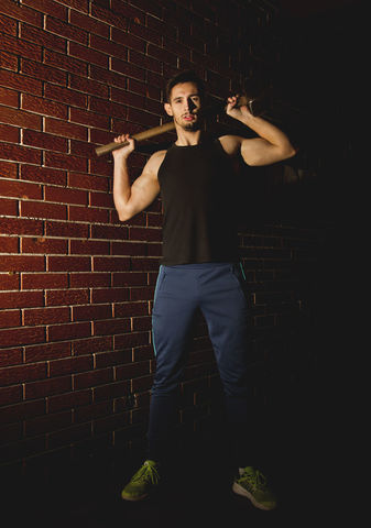 Portrait of man holding hammer while | ID: 99255281