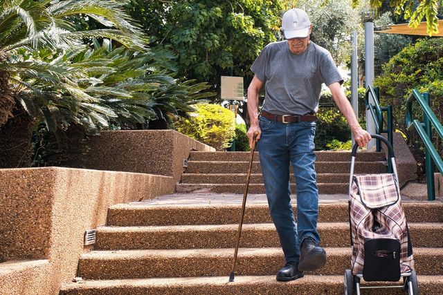 Elderly Disabled Person With A Stick Walks | Id: 213863734
