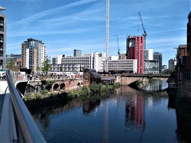 Bridge over river by buildings in city | ID: 141448339