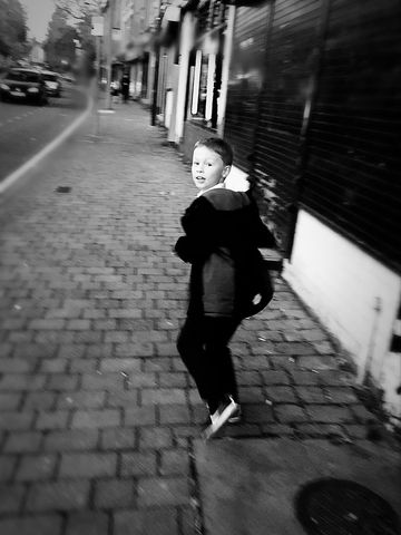 High angle portrait of boy running on street | ID: 74558015