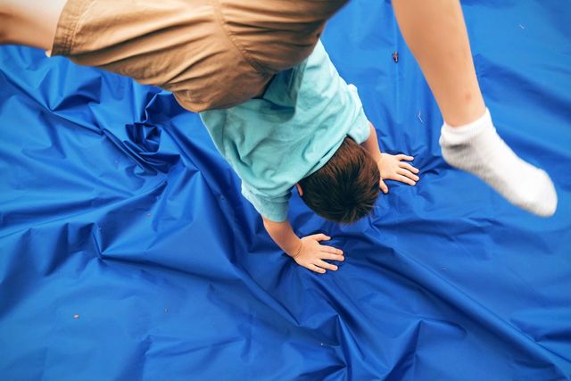 High angle view of boy performing handstand | ID: 94927335