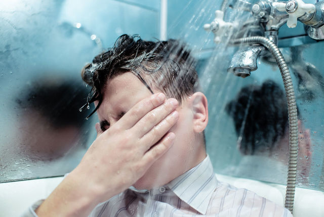 Close-up of depressed man sitting in bathtub | ID: 96410483