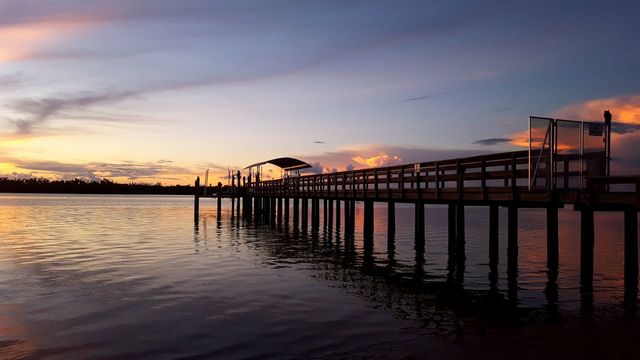 Pier over sea against sky during sunset | ID: 135922041