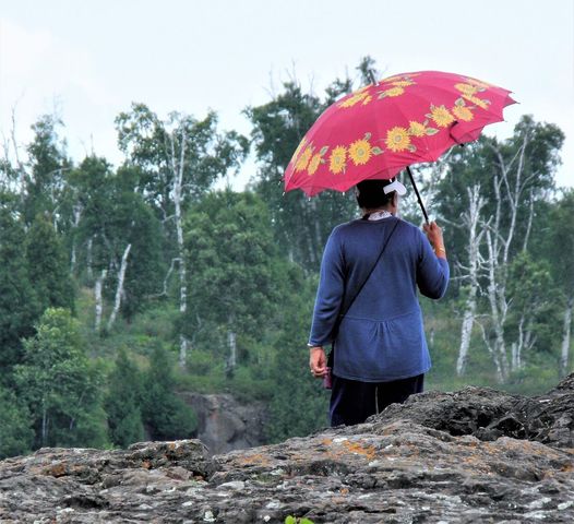 Rear view of man standing in rain | ID: 125976152