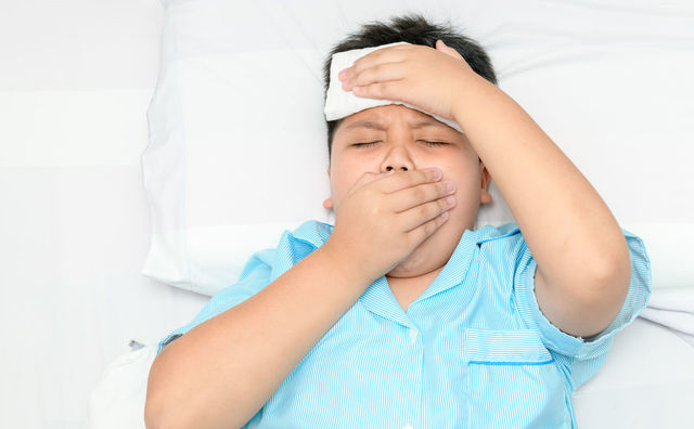 High angle view of boy in fever yawning on | ID: 149757501