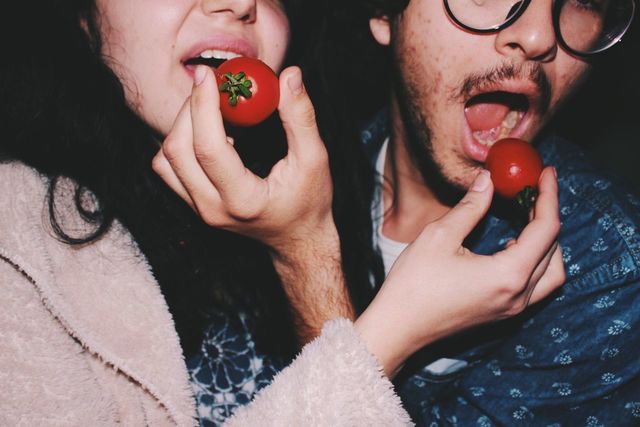 Close-up of people eating tomatoes | ID: 101921206