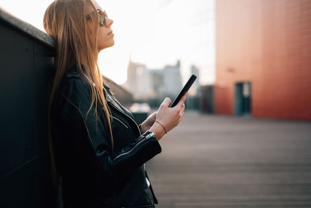 Side view of woman using mobile phone while | ID: 132252710