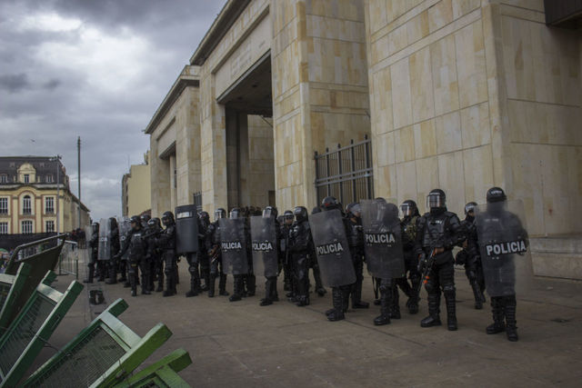 Police force with shields on street | ID: 85375965