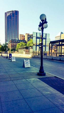 Street light on footpath in city against sky | ID: 70987946