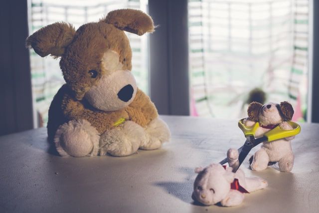 Stuffed toys with scissor on table at home | ID: 73704321