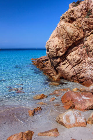 Rock formation on beach against clear blue | ID: 129179683