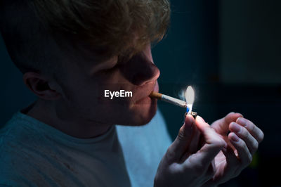 man lighting cigarette