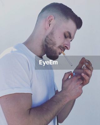 man lighting cigarette reference