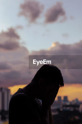 man crying at sunset