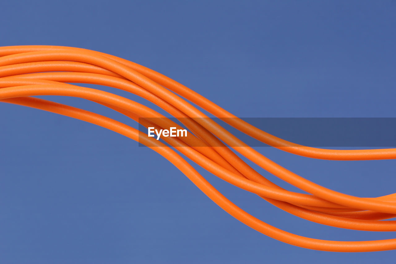 Close-up of orange cables against blue | ID: 88167227