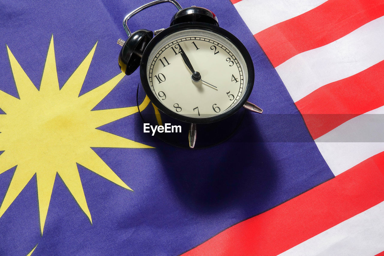 High angle view of alarm clock on malaysian | ID: 122122864
