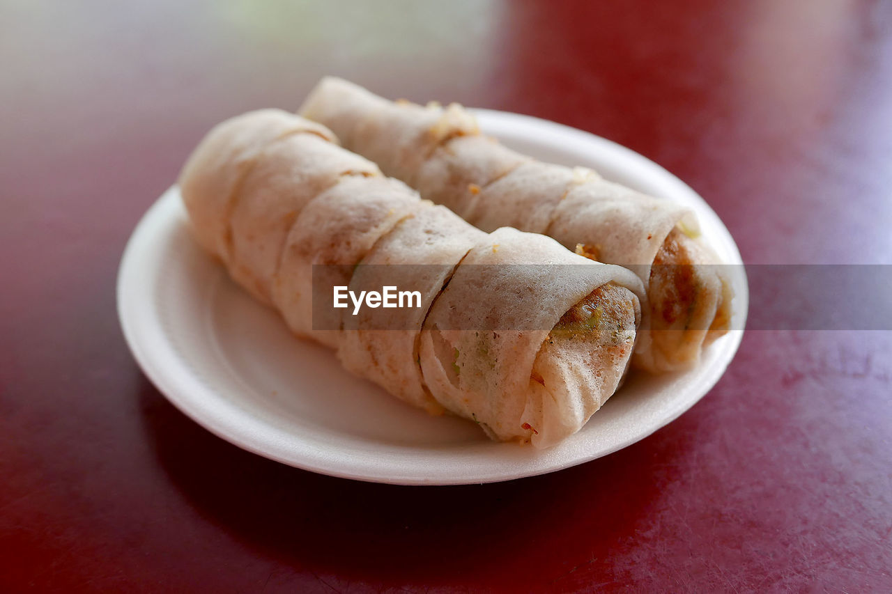 Close-up of fresh popiah served in plate on | ID: 74527317