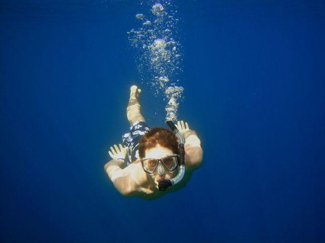 Young man looking at camera while snorkeling | ID: 92572594