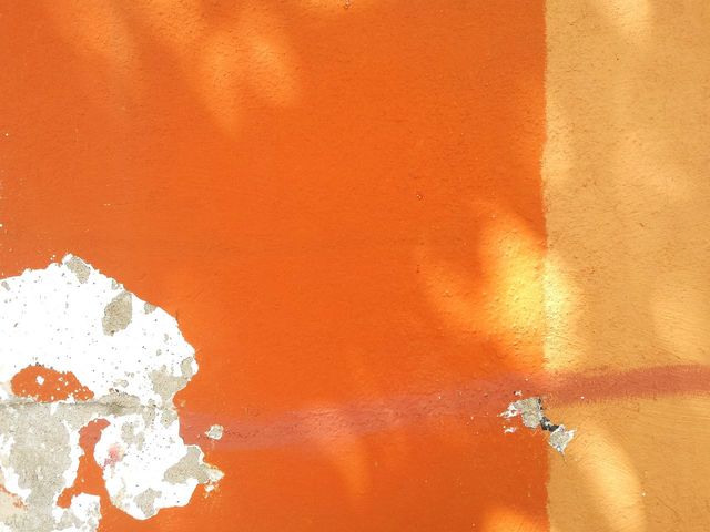 Close-up of damaged orange wall | ID: 93731273