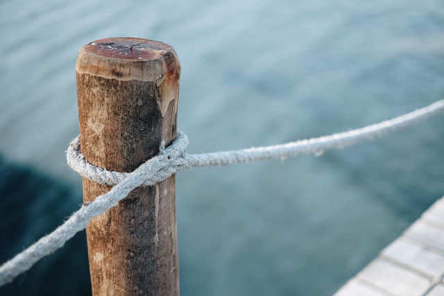 Close-up of rope tied to wooden post at | ID: 132774733