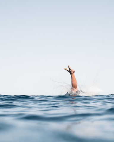 Man swimming in sea against clear sky | ID: 196490106