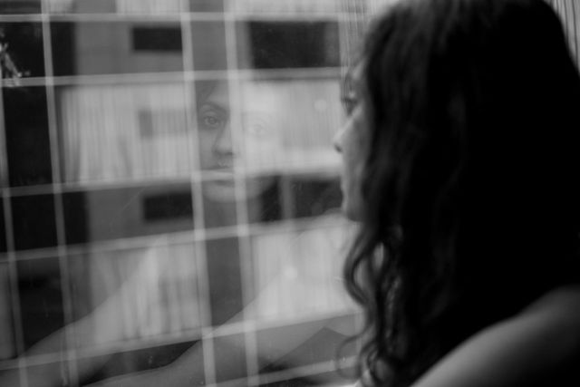 Side view of young woman looking through | ID: 196342286