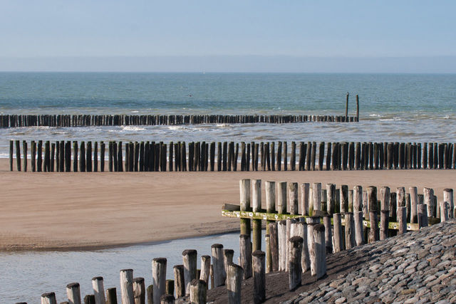 Wooden posts on beach against sky | ID: 101023129