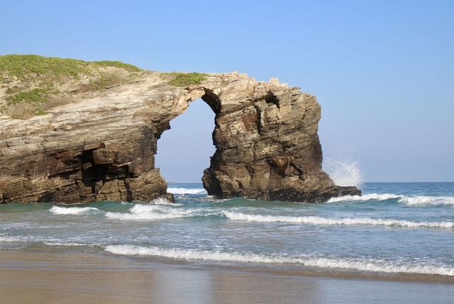 Rock formation on beach against clear sky | ID: 122467596
